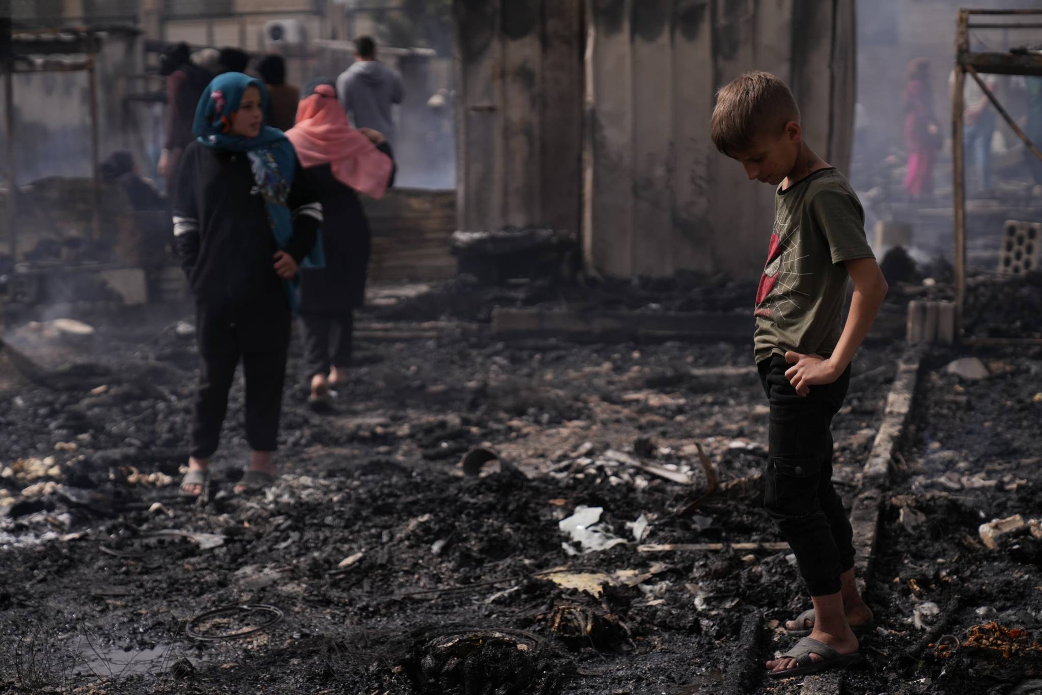 Fire in refugee camp, three injured in Israeli strike, Mass grave in ...