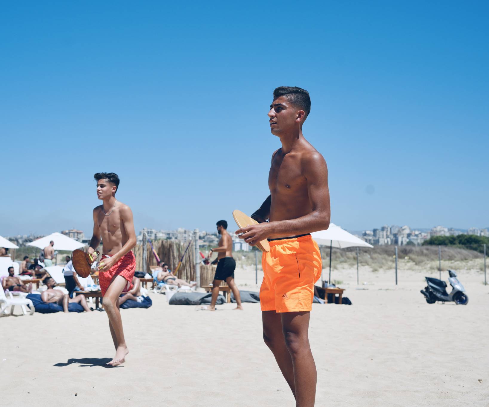In Sour, beachgoers bathe in the water while Israeli bombs fall in the ...