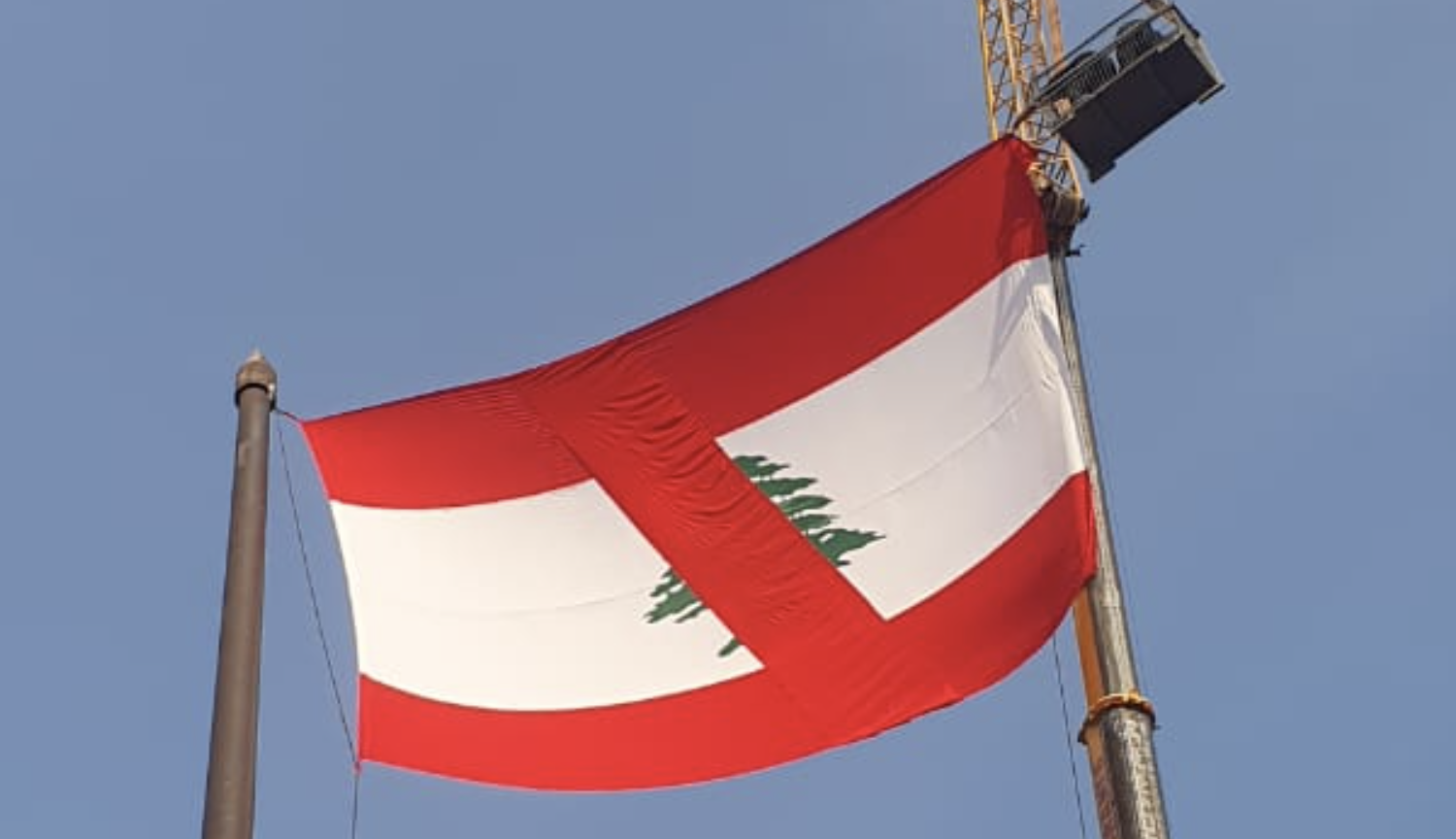 Behind the Lebanese flag with a red stripe in the heart of Beirut... a ...
